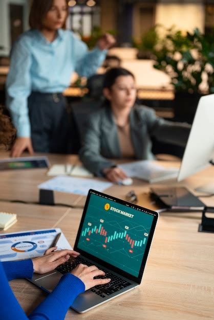 People Analyzing And Checking Finance Graphs In The Office Premium Photo