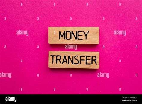 money transfer message written on wooden blocks with pink background