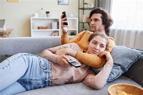 Premium Photo Portrait Of Young Couple Cuddling On Sofa At Home And
