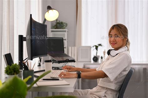 Young Female Developer Working With Coded Data On Computer Screen