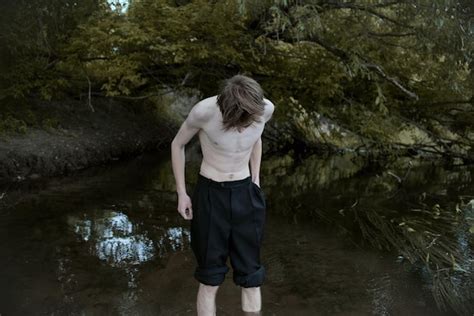 Premium Photo Shirtless Man Standing In Lake