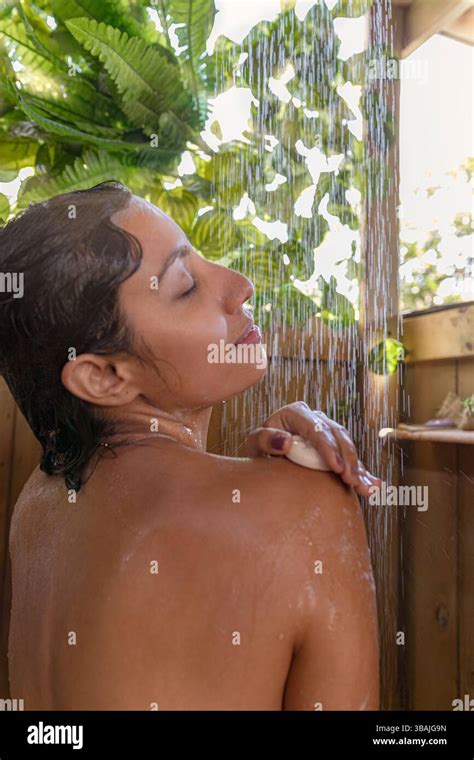 A Woman Finds Serenity And Bliss In A Relaxing Outdoor Shower At A