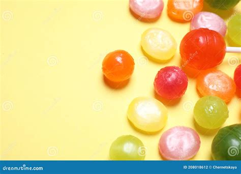 Many Different Hard Candies On Yellow Background Closeup Space For