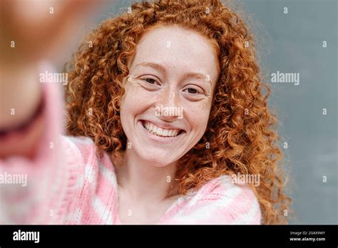 Cheerful Redhead Woman With Curly Hair Smiling Stock Photo Alamy