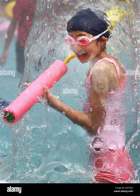 A Taiwanese Girl Squirts With A Water Gun In Summer Heat At Taipei Water Museum In Taipei