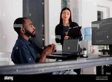 Multi Ethnic System Engineers Collaborating On Programming Project