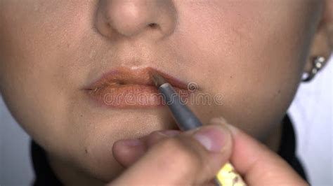 Close Up Makeup Artist Making Professional Make Up For Young Woman In