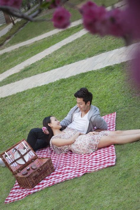 Jong Gelukkig Paar Die Op Een Deken Liggen Samen Terwijl Het Hebben Van Een Picknick In Het Park