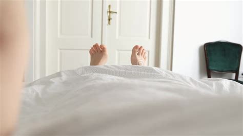 Woman S Barefoot In Close Up Funny Stretching Lying On Bed White Bedding White Vintage