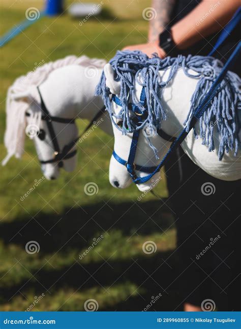 Hobby Horsing Competition On A Green Grass Hobby Horse Riders Jumping