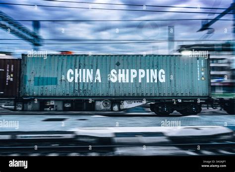 Rushing Through The Station Global Trade On Track China Shipping Container Captured In Motion