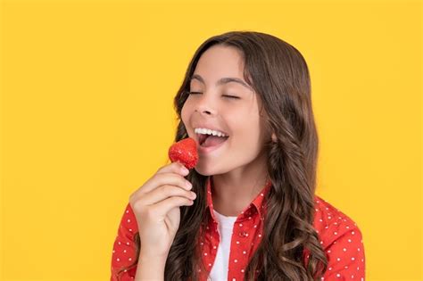 Premium Photo Happy Teen Girl Eat Strawberry On Yellow Background