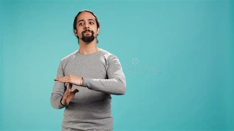 Portrait Of Assertive Man Asking For Timeout Doing Hand Gestures Stock
