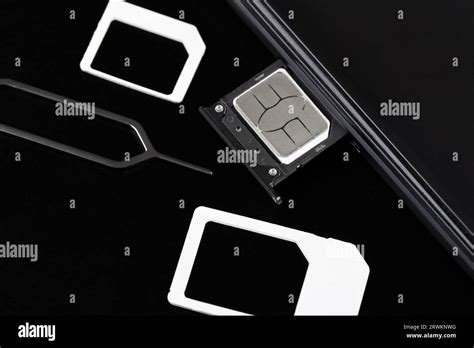 SIM Card Inserted Into The Sim Card Tray Of A Smartphone With Pin Needle Tray Remover Stock