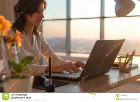 Side View Photo Of A Female Programmer Using Laptop Working Typing Surfing The Internet At