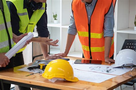 아시아 엔지니어들은 비용 견적을 문서화하고 주택 및 건물의 건축 및 엔지니어링 설계를 위한 평면도를 작성하기 위해 브레인스토밍 및 측정합니다 계획에 대한 스톡 사진 및 기타