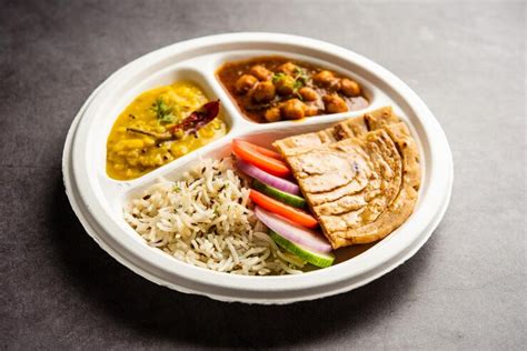 Free Photo Indian Mini Meal Parcel Platter Combo Thali With Chole Masala Roti Dal Tarka Jeera