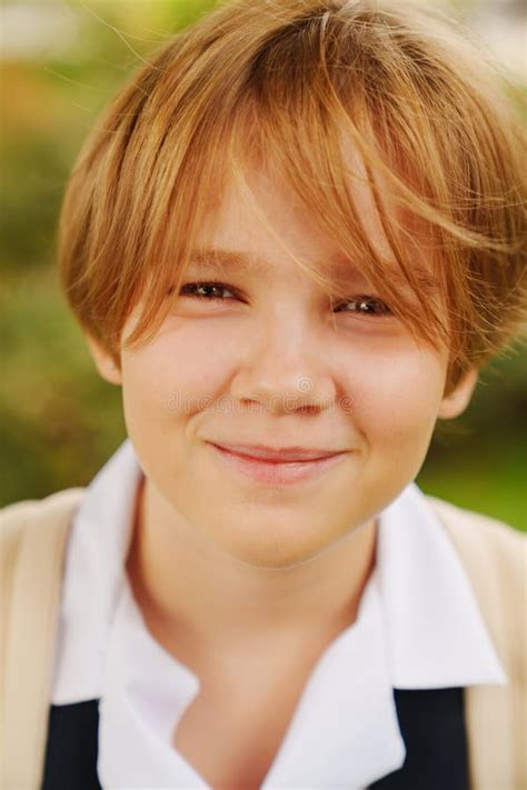 Portrait Of Lilt Blonde Teenage Girl With Short Haircut In School