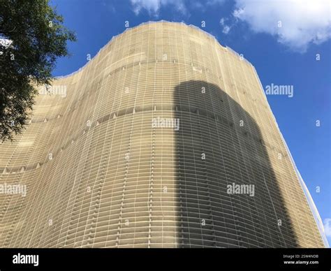 A Modern Architectural Structure With A Unique Wavy Facade And Grid