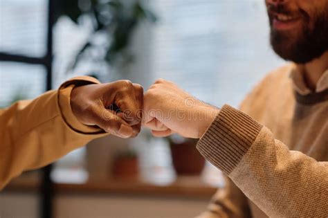 Two Men Bumping Their Fists Together Stock Photo Image Of Indoors Partnership