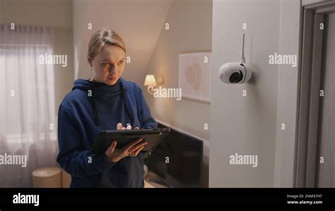 Caucasian Woman Installs Security Camera Woman Sets Up Angle Of Cctv