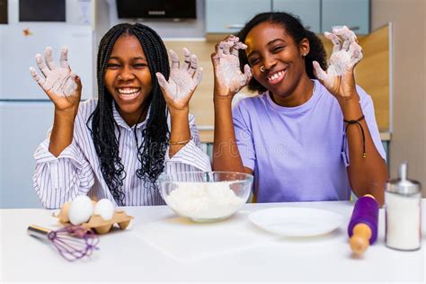 Happy Loving Same Sex Couple Is Preparing The Pastry In The Kitchen Showing Hands With Flour