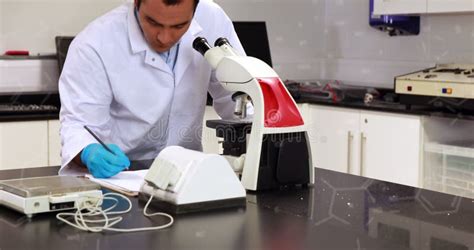 Animation Of Chemical Formulas Over Biracial Male Lab Worker Using Microscope Stock Video