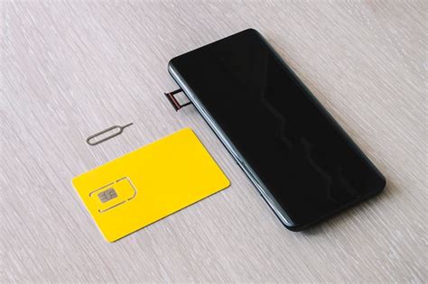 Premium Photo SIM Card And MicroSD Card Tray With Removal Tool At The Side Of Smartphone On