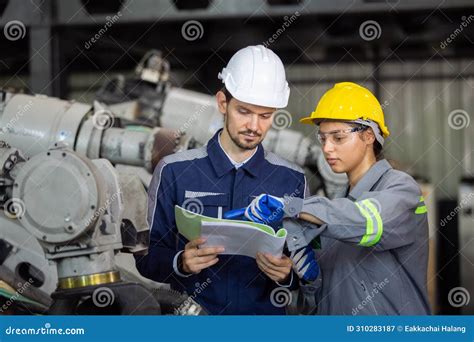 Engineers Working Robot Assembly Industry Plant In Factory Examining Condition Inspection