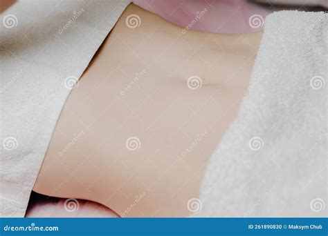 Belly Of A Young European Woman On A Massage Bed Preparation For