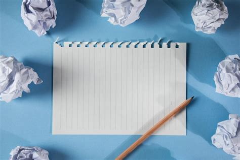 Premium Photo Crumpled Paper Balls And Notebook Pen