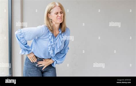 A Blonde Woman Is Suffering Because She Has Appendix Pain Stock Photo Alamy