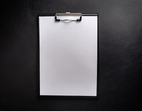 clipboard with blank paper on a dark textured surface ready for notes