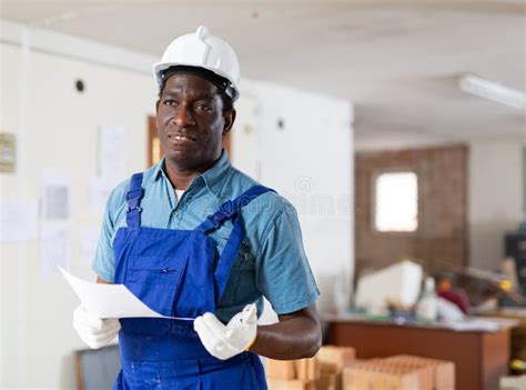 Man Construction Worker With Document Inside Apartment Stock Image