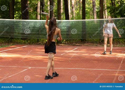 Badminton Player On Badminton Court Two Girls Play In The Park In