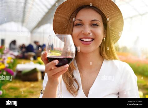 Photo Of Happy Cheerful Woman Holds Wine Glass Makes Toast Looking At