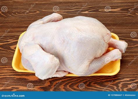 Fresh Raw Chicken Carcass Or Broiler Chicken On A Yellow Plastic Pallet