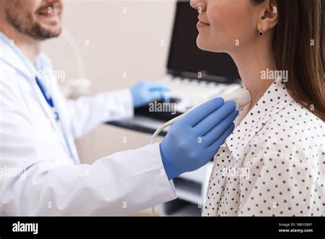 Sonographer Conducting Ultrasound Examination Of Womans Thyroid Gland In Clinic Closeup Stock