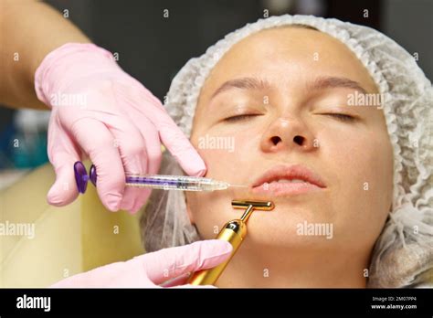 Contour Plastic A Cosmetologist Injects A Botulinum Toxin To Tighten