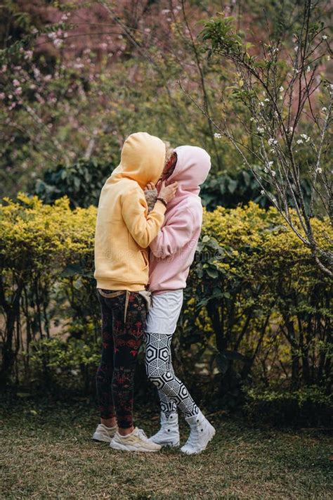 Lesbian Couple Hugging In Sakura Garden Stock Photo Image Of Couple Blonde