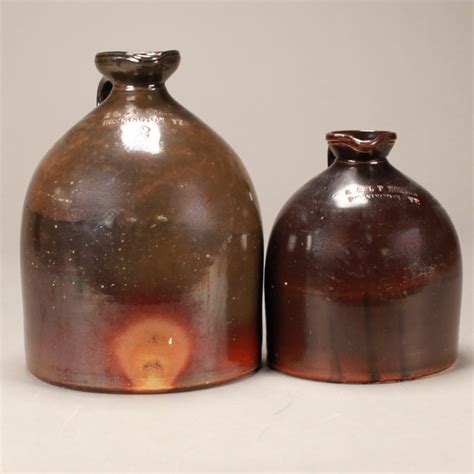 Lot 023 Two Brown Stoneware Syrup Jugs 1 2 Gallon Marked E And Lp