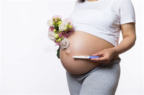 Close Up Gravid Woman Holding A Positive Pregnancy Inkjet Test And
