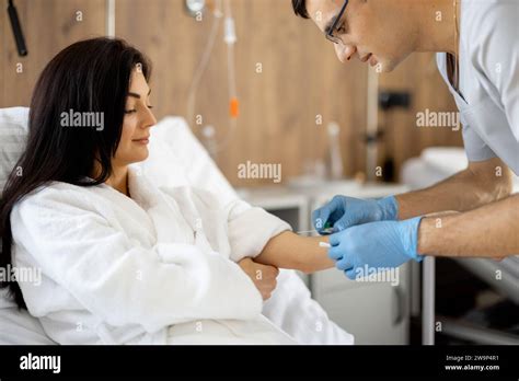 Nurse Inserts Catheter To A Female Patient In Medical Ward Stock Photo Alamy
