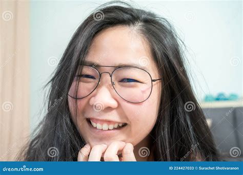 Close Up To Confident Young Asian Small Eye Woman Is Smiling In Her