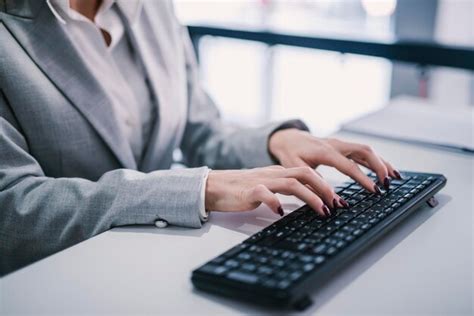 Premium Photo Close Up Of Hands Typing On Keyboard At Office
