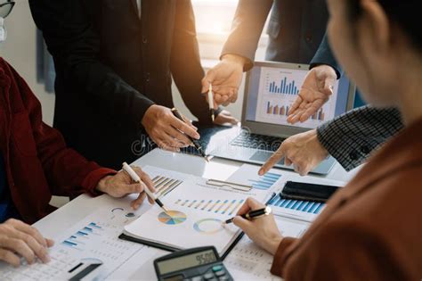 Businessmen Team Or Financial Data Analysts Working With Tablets And Laptop Computers And Data