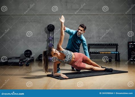 Trainer Showing Right Position To Do Abs In A Gym Hiit Class Stock