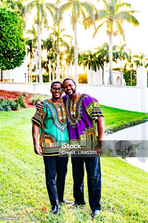 Two Adult Men Dressed In Dashikis Traditional African Clothing To Celebrate Kwanzaa In Happy