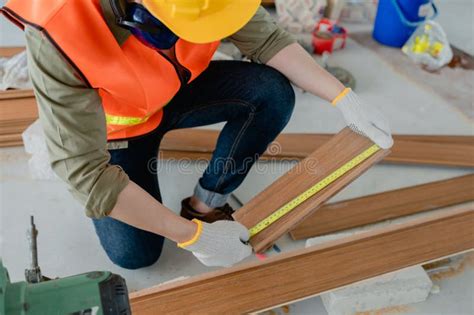 Structural Worker Dressed In Safety Gear And Hard Hat Doing Construction And Using Circular Saw