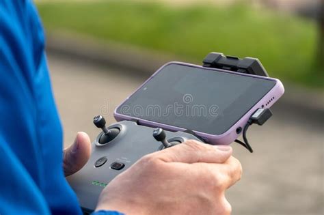 The Operator Holds The Remote Control Of The Drone In His Hands A Farmer Uses A Quadcopter To